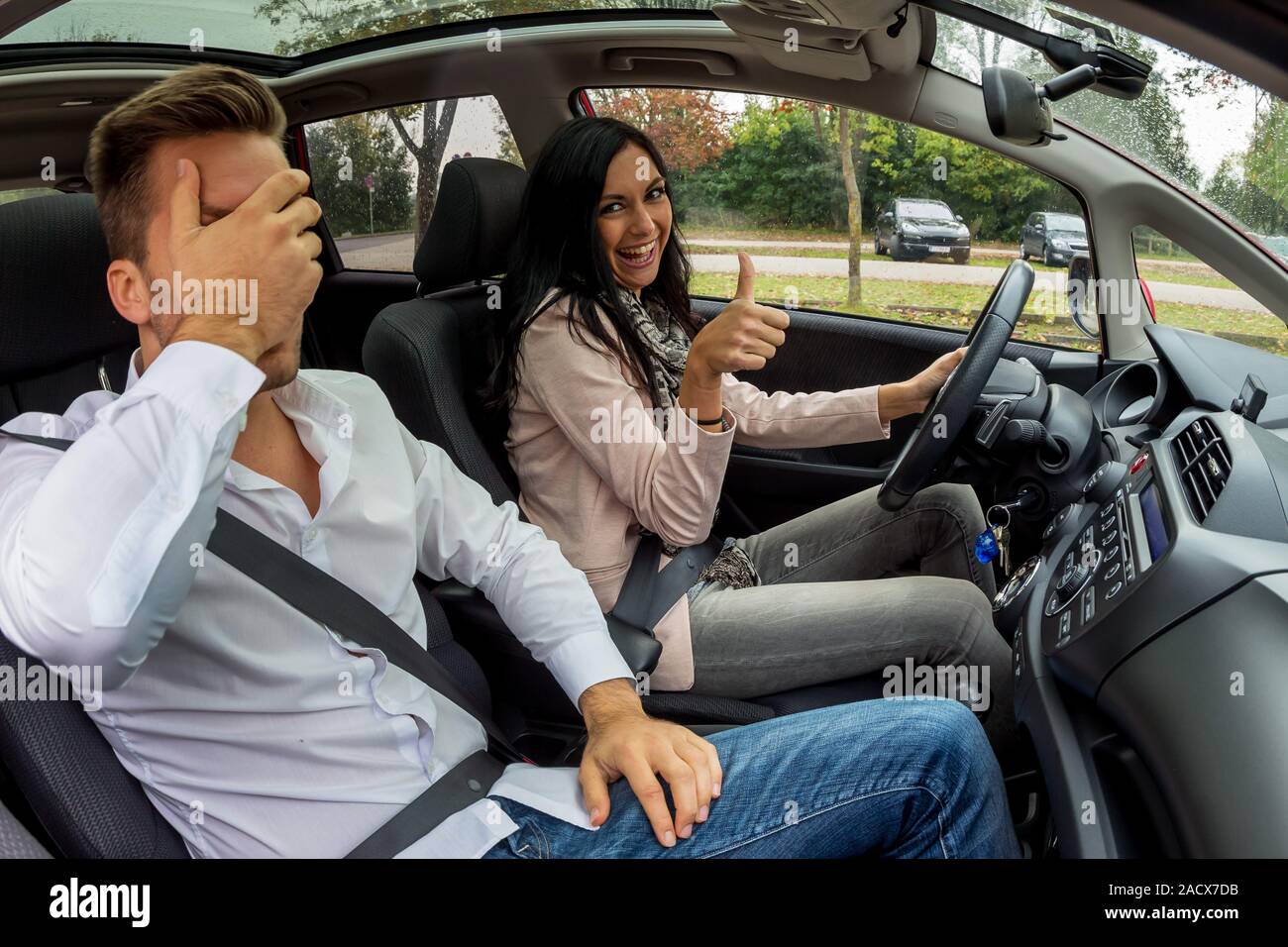 Couple driving in a car Stock Photo - Alamy