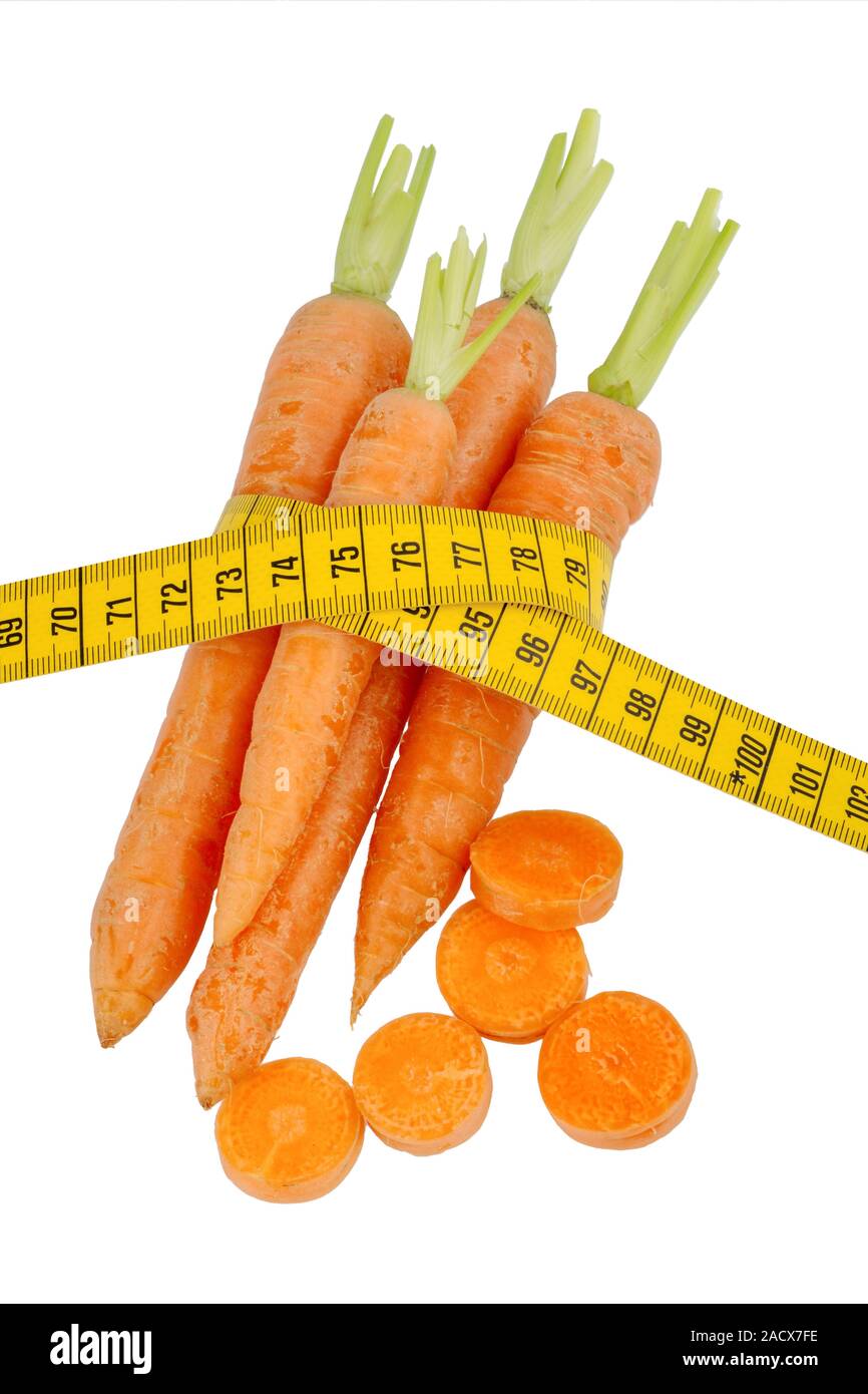 Fresh carrots with tape measure Stock Photo - Alamy