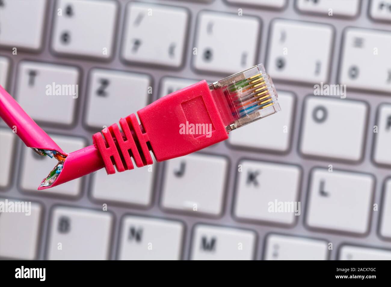 Defective network cable on keyboard Stock Photo - Alamy