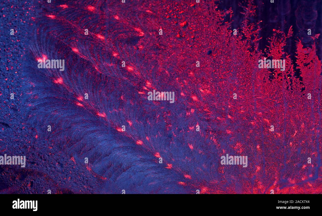 Frost patterns are seen on the window of a warm house in the winter in ...