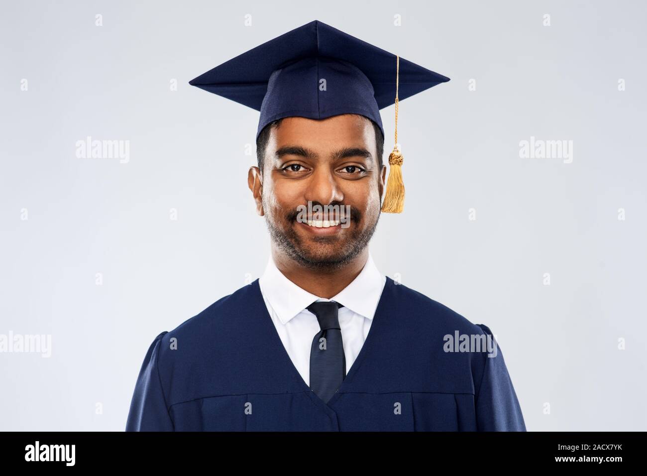 education, graduation and people concept - happy smiling indian male ...