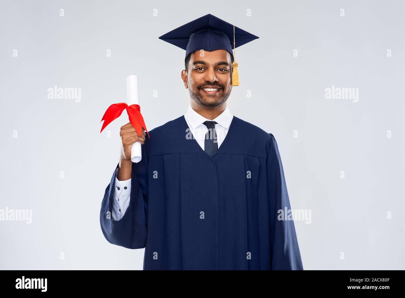 education, graduation and people concept - happy smiling indian male ...