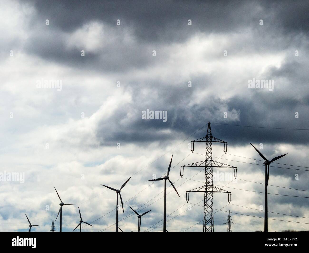 Wind turbine and power pylons Stock Photo - Alamy