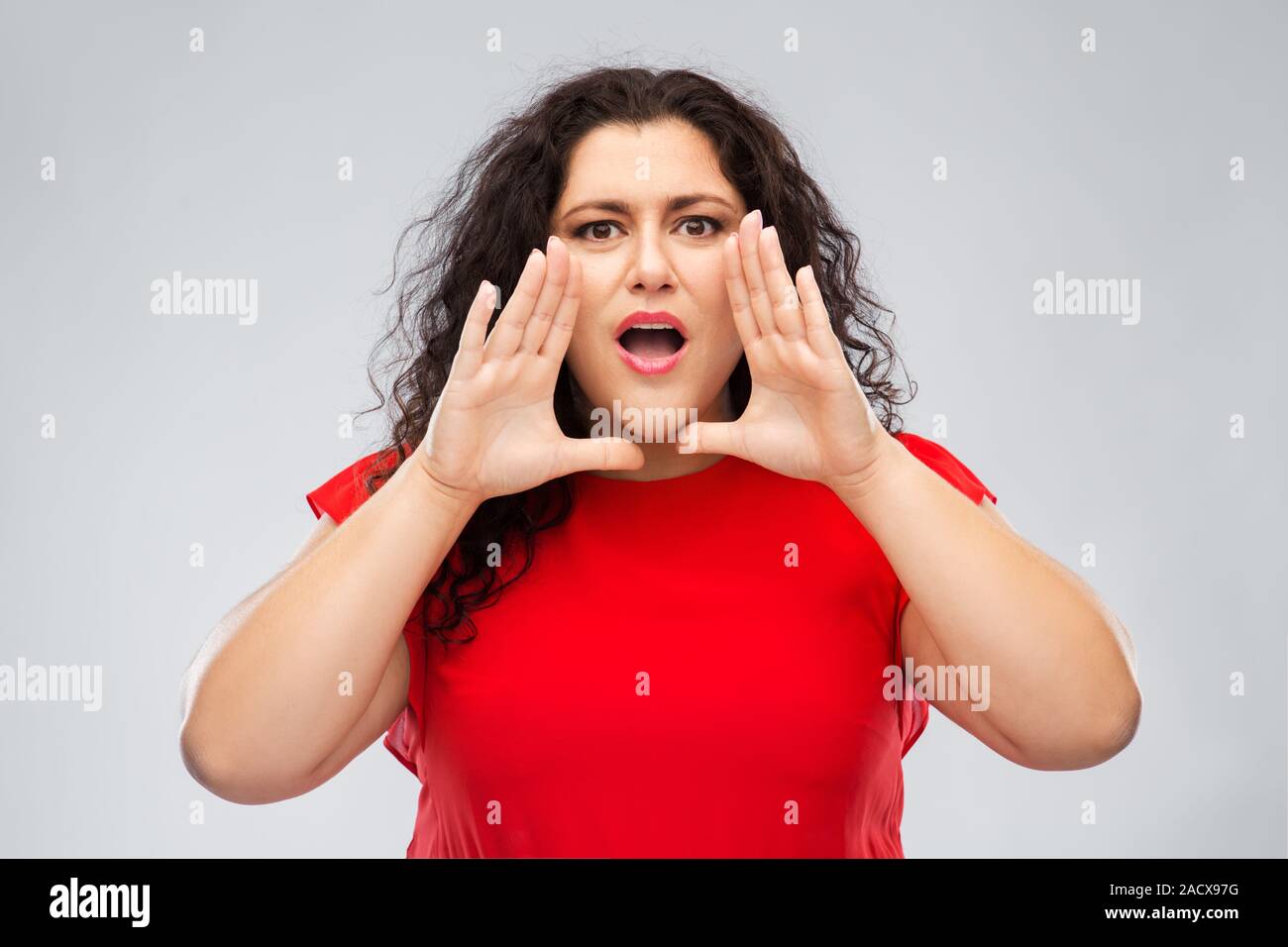 warning, communication and caution concept - worried woman in red dress ...