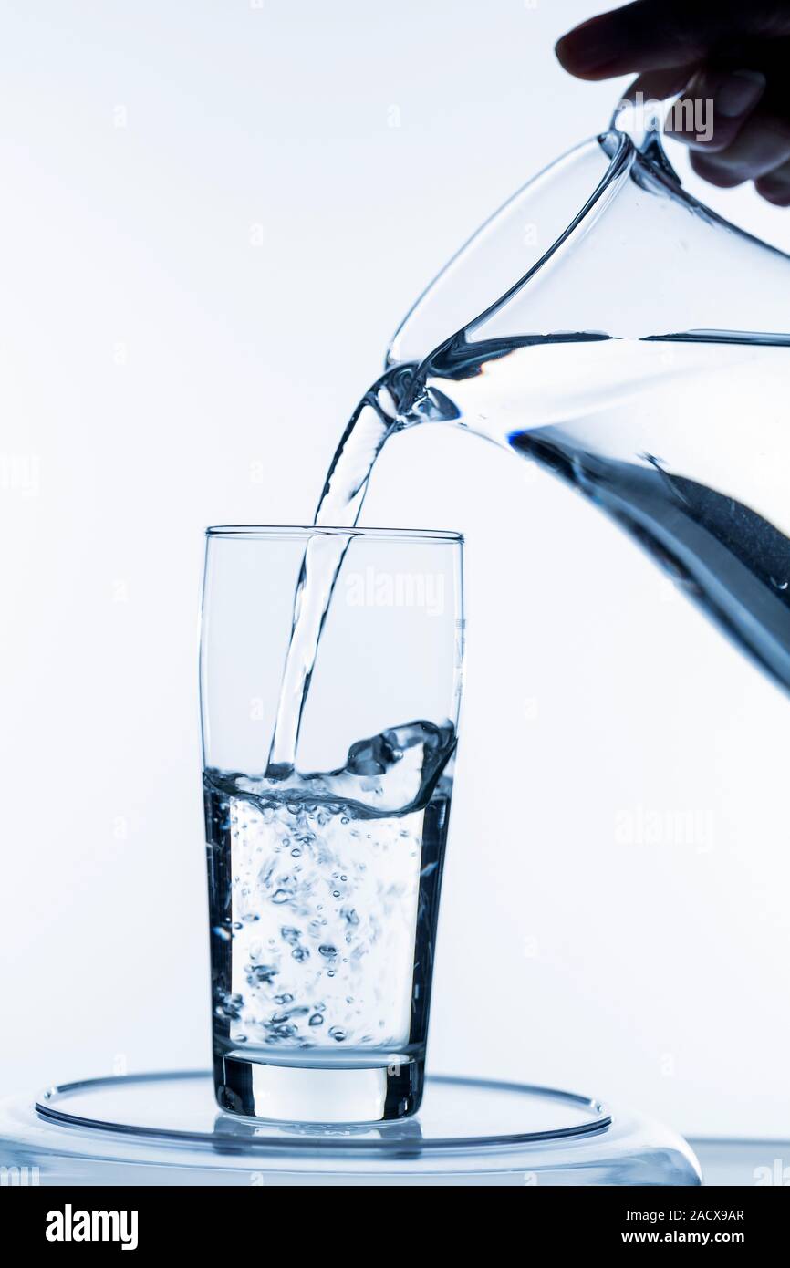 Glass with water and jug Stock Photo - Alamy