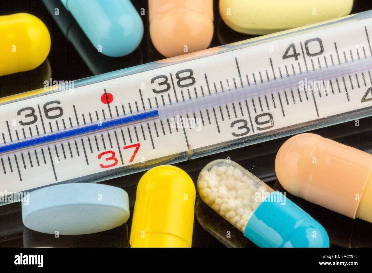 Fever thermometers and tablets Stock Photo - Alamy