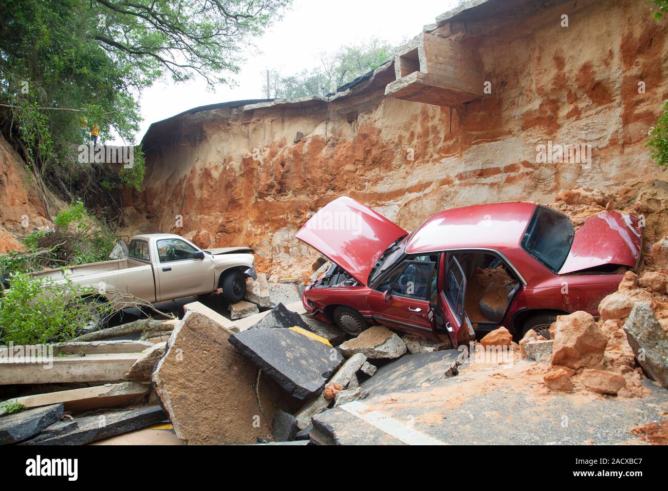 Cars and road washed out by flooding. This road was destroyed by ...