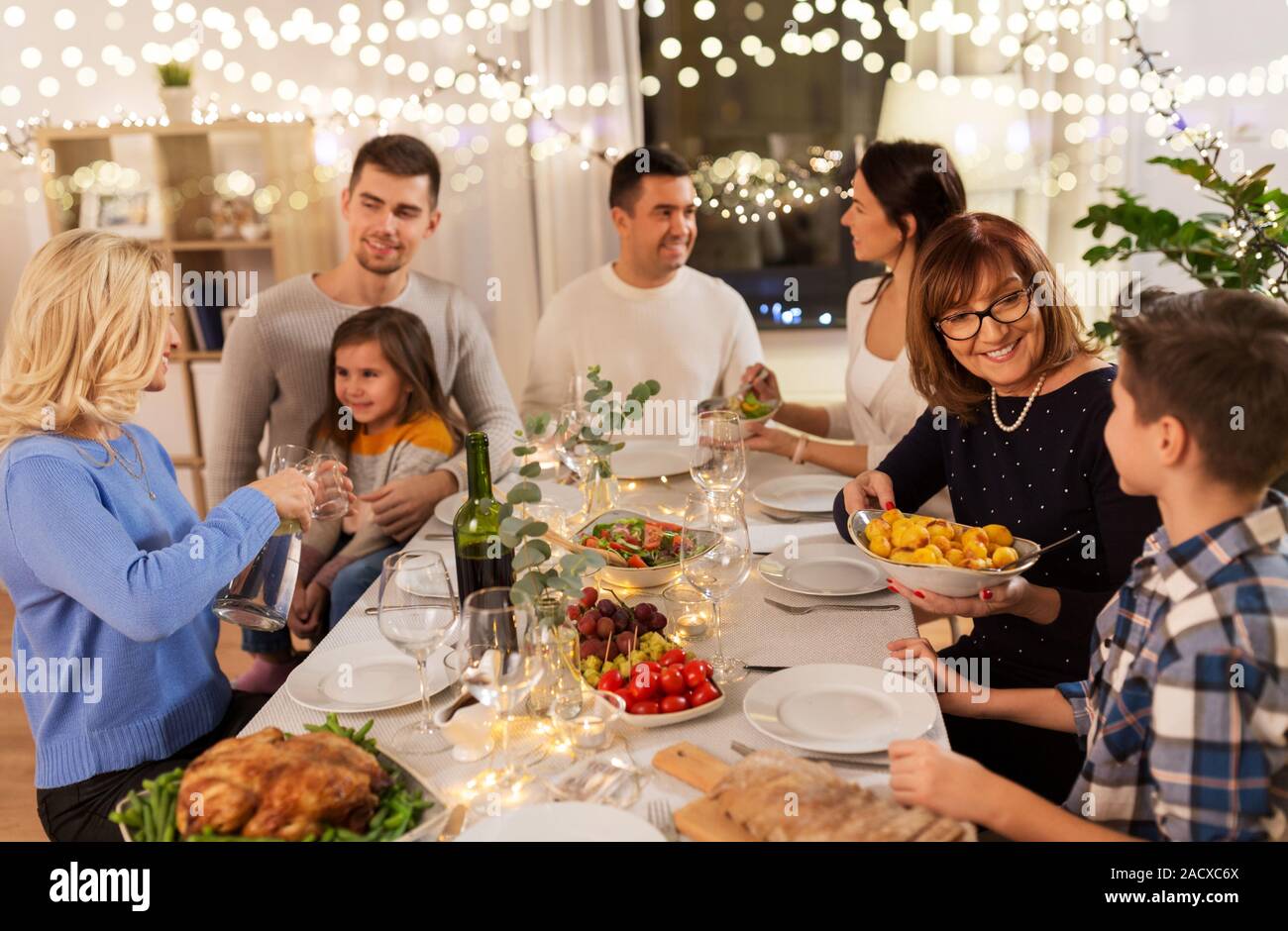 celebration, holidays and people concept - happy family having dinner ...