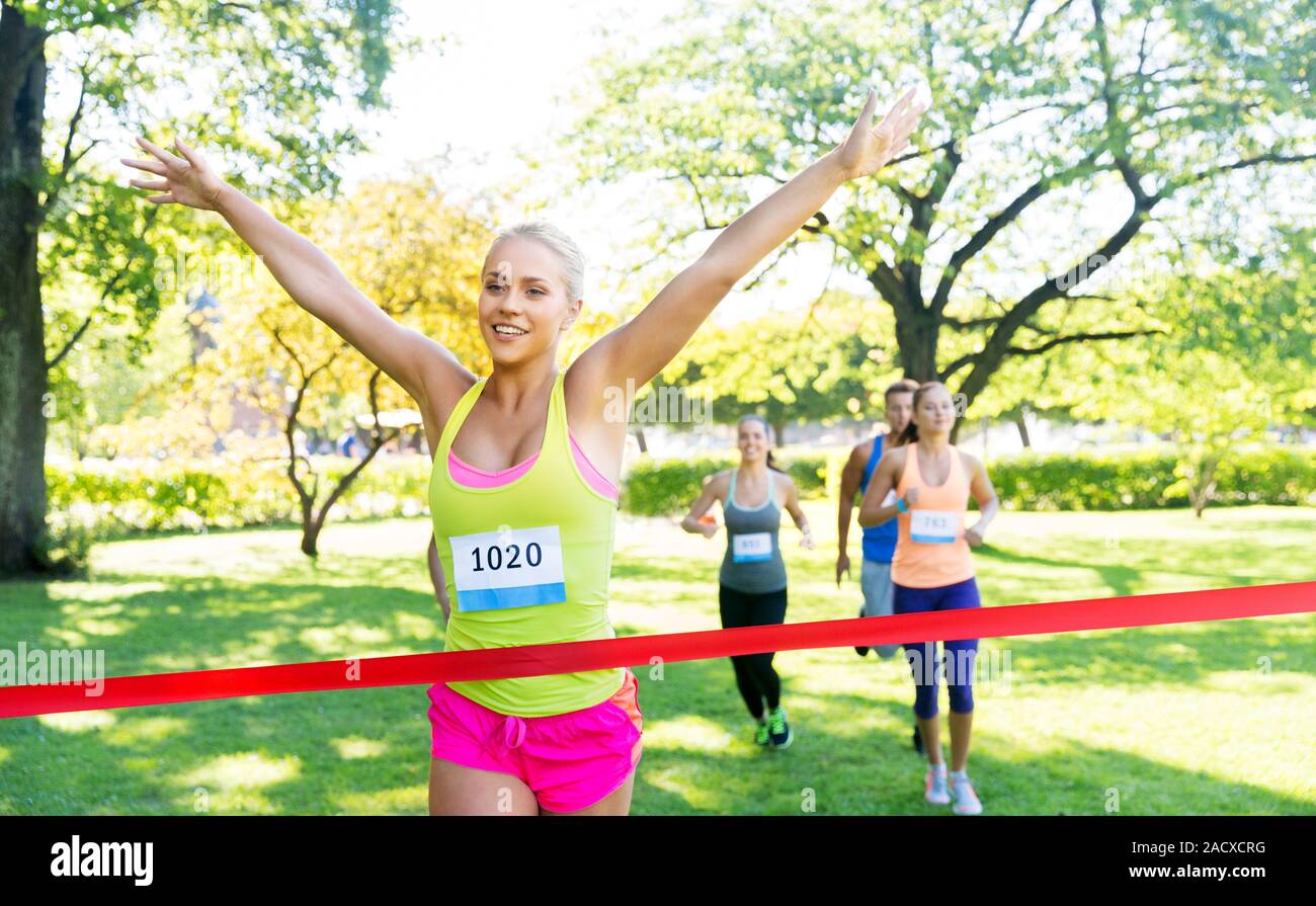 fitness, sport and success concept - happy woman winning race and ...