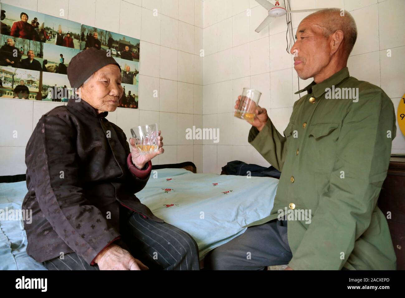 Urine therapy. A urine therapist (right) visiting an 88 year old woman ...
