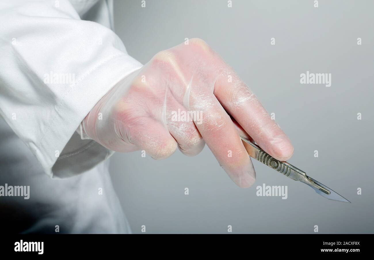 Doctor holding a scalpel Stock Photo - Alamy