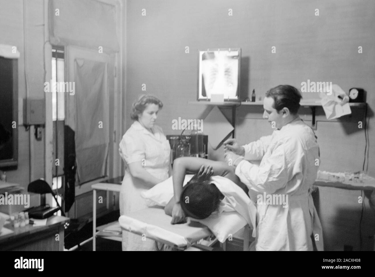 Doctor treating a tuberculosis patient by inducing a pneumothorax ...