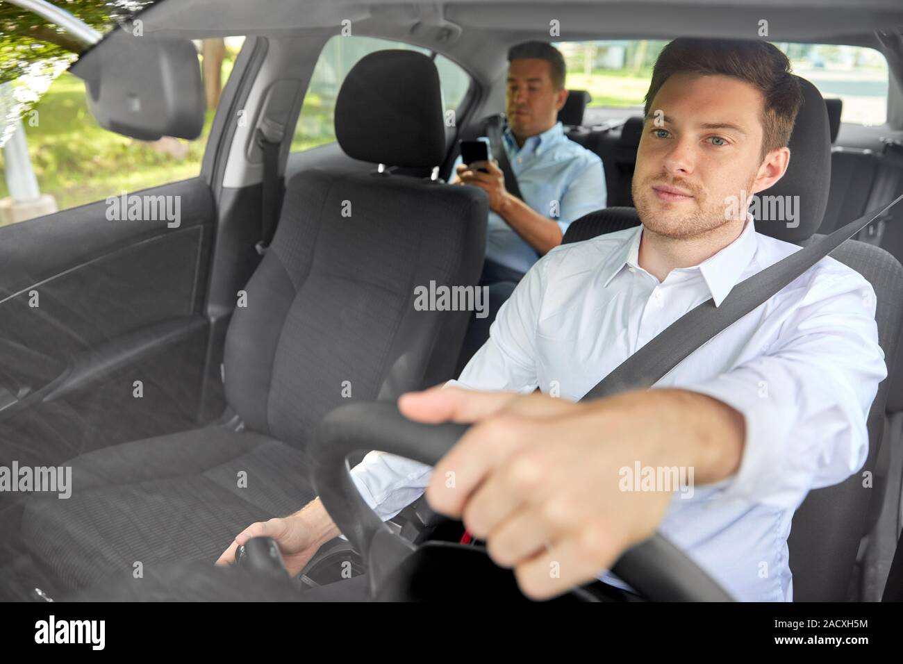 transport, vehicle and taxi concept - male driver driving car with ...