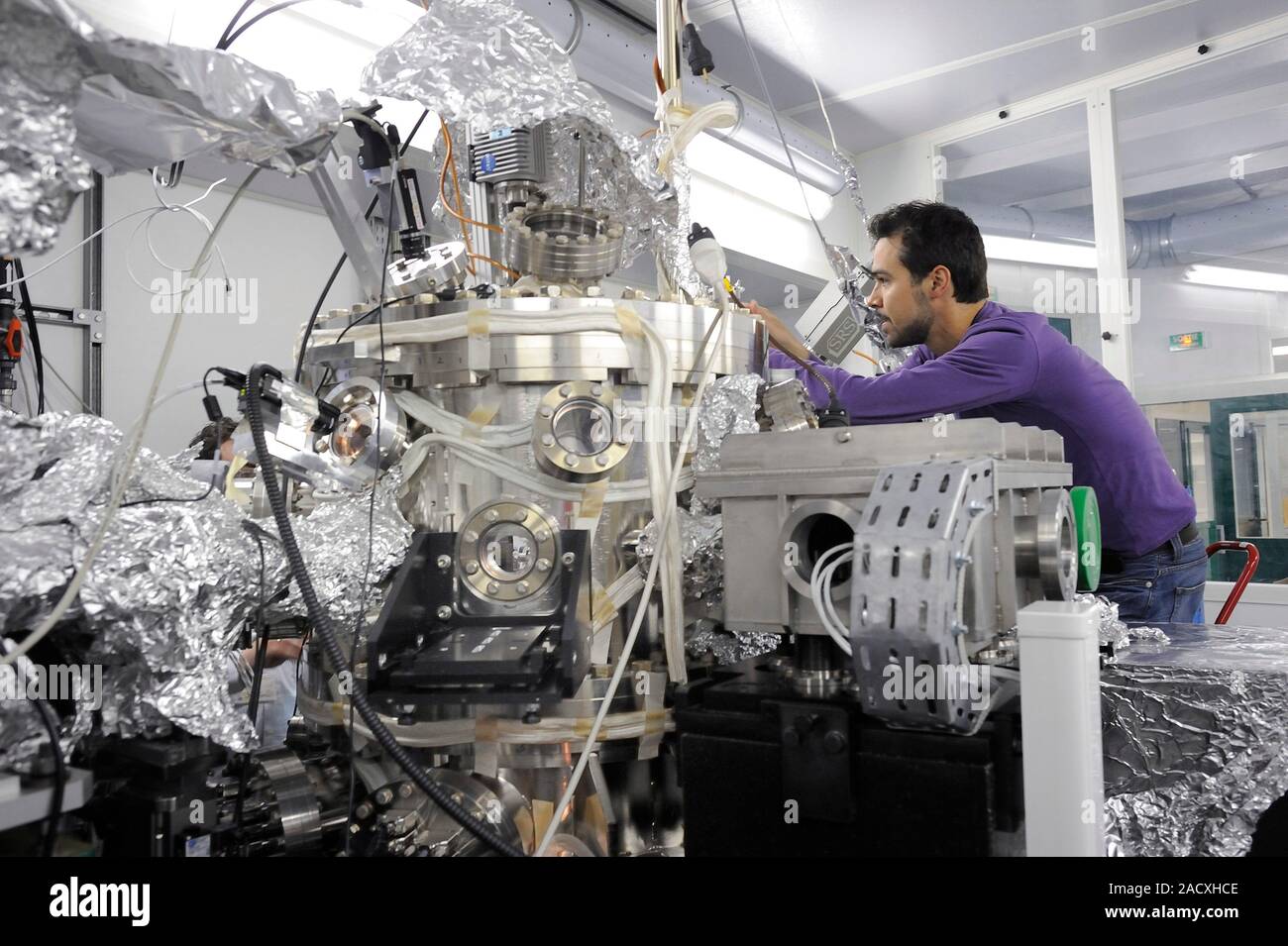 Silicene research. Researchers inspecting a particle accelerator in a materials science research ...