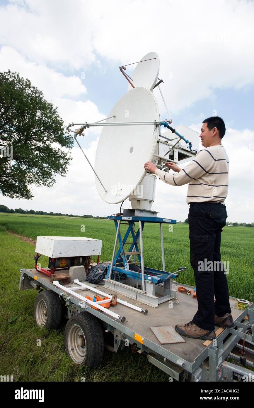 Insect radar research. Radar scientist Jason Lim standing on a portable ...
