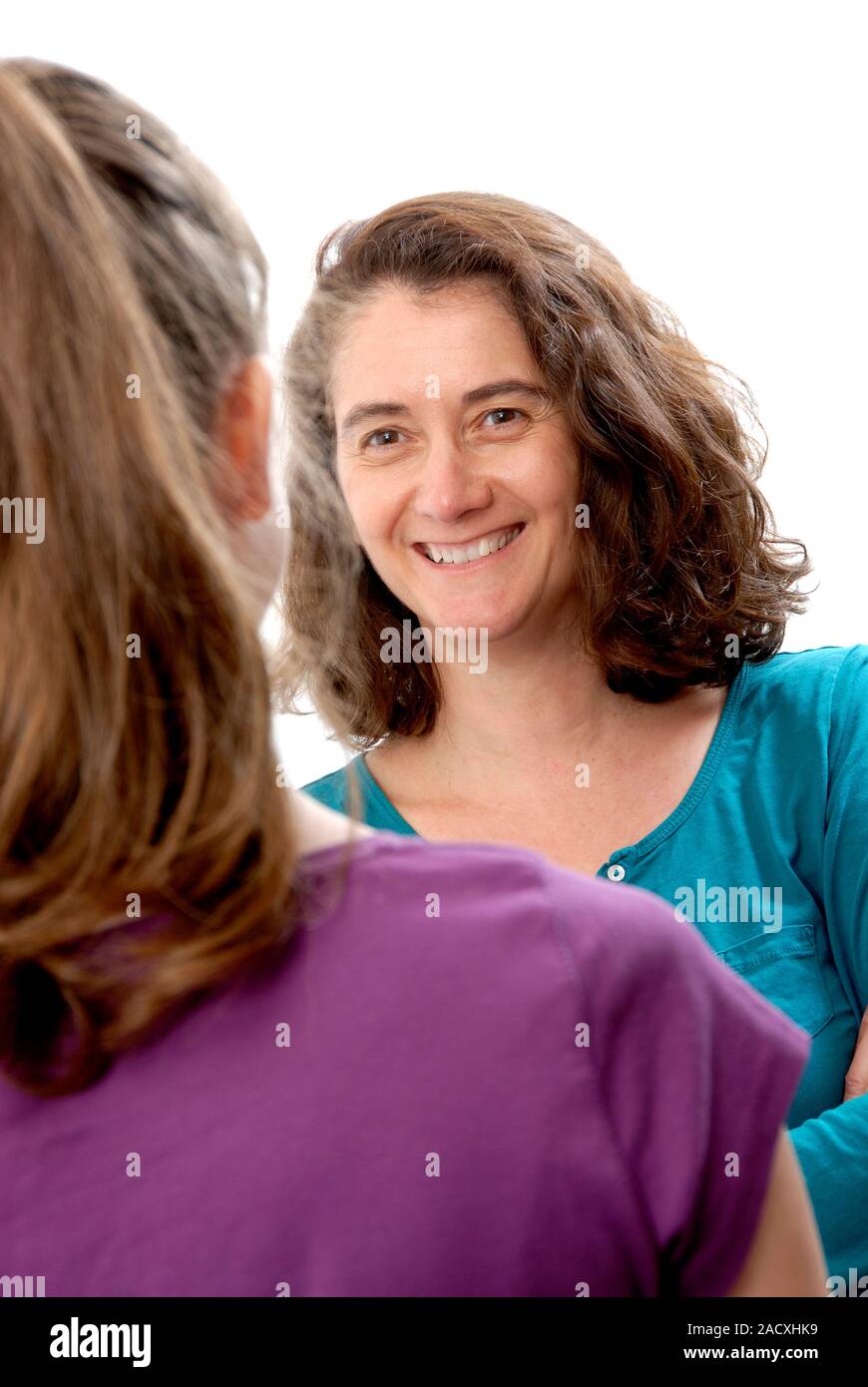 Mother and teenage daughter. Smiling mother talking to her 16-year-old ...
