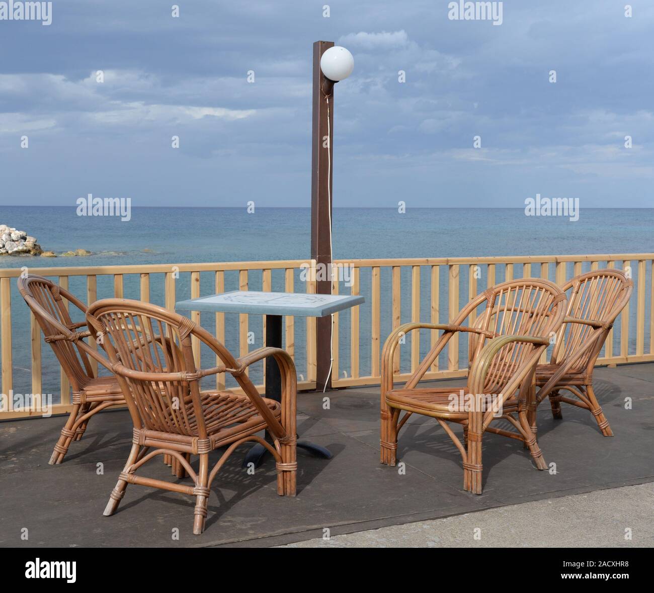 Table and chairs by the sea Stock Photo - Alamy