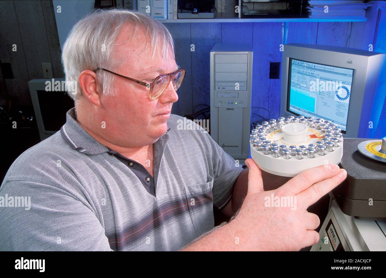 Environmental nitrogen analysis. Technician preparing gas chromatograph ...