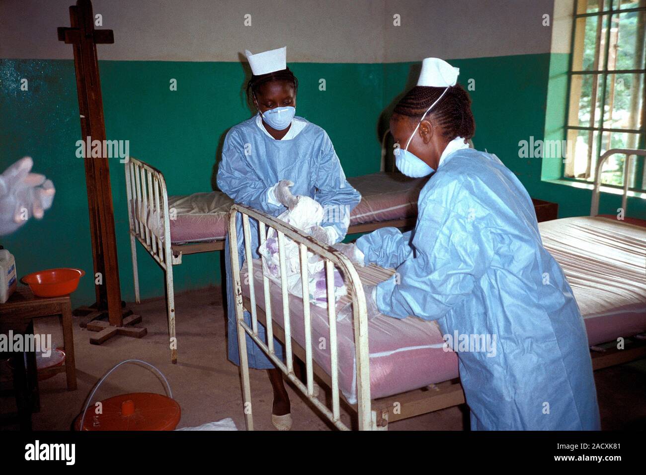 Nurses wore protective clothing while changing bedding on an ebola ...