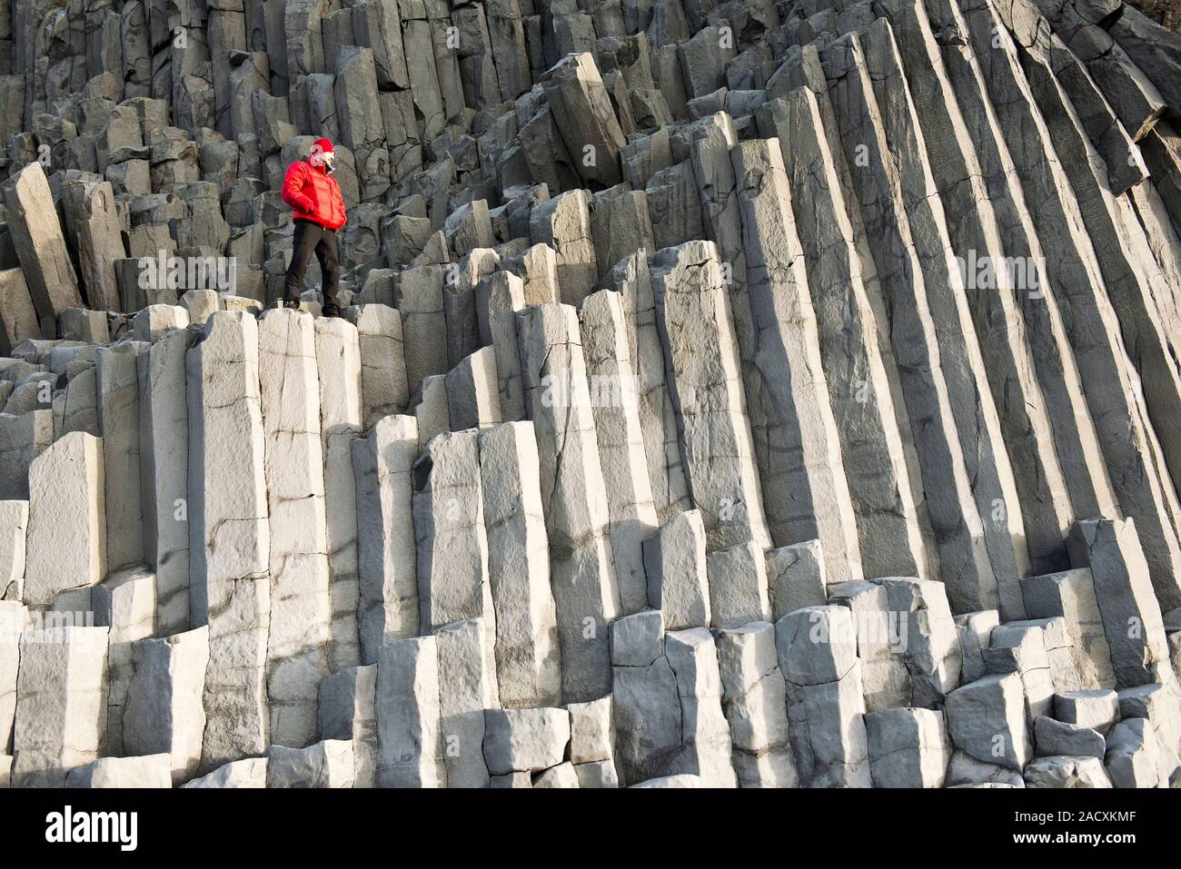 Basalt columns, with a man standing at upper left. These columns of ...