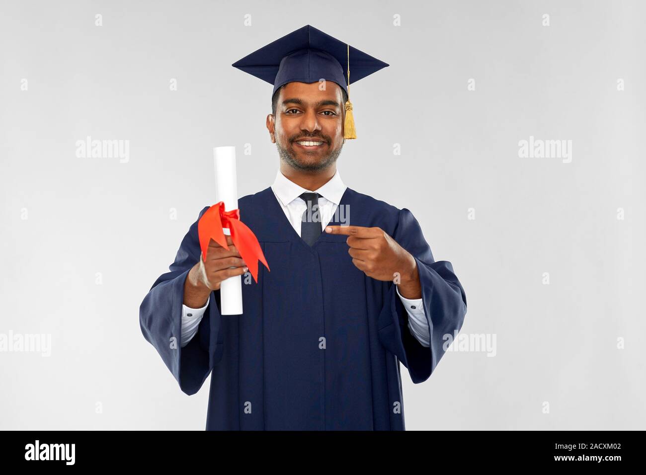 education, graduation and people concept - happy smiling indian male ...