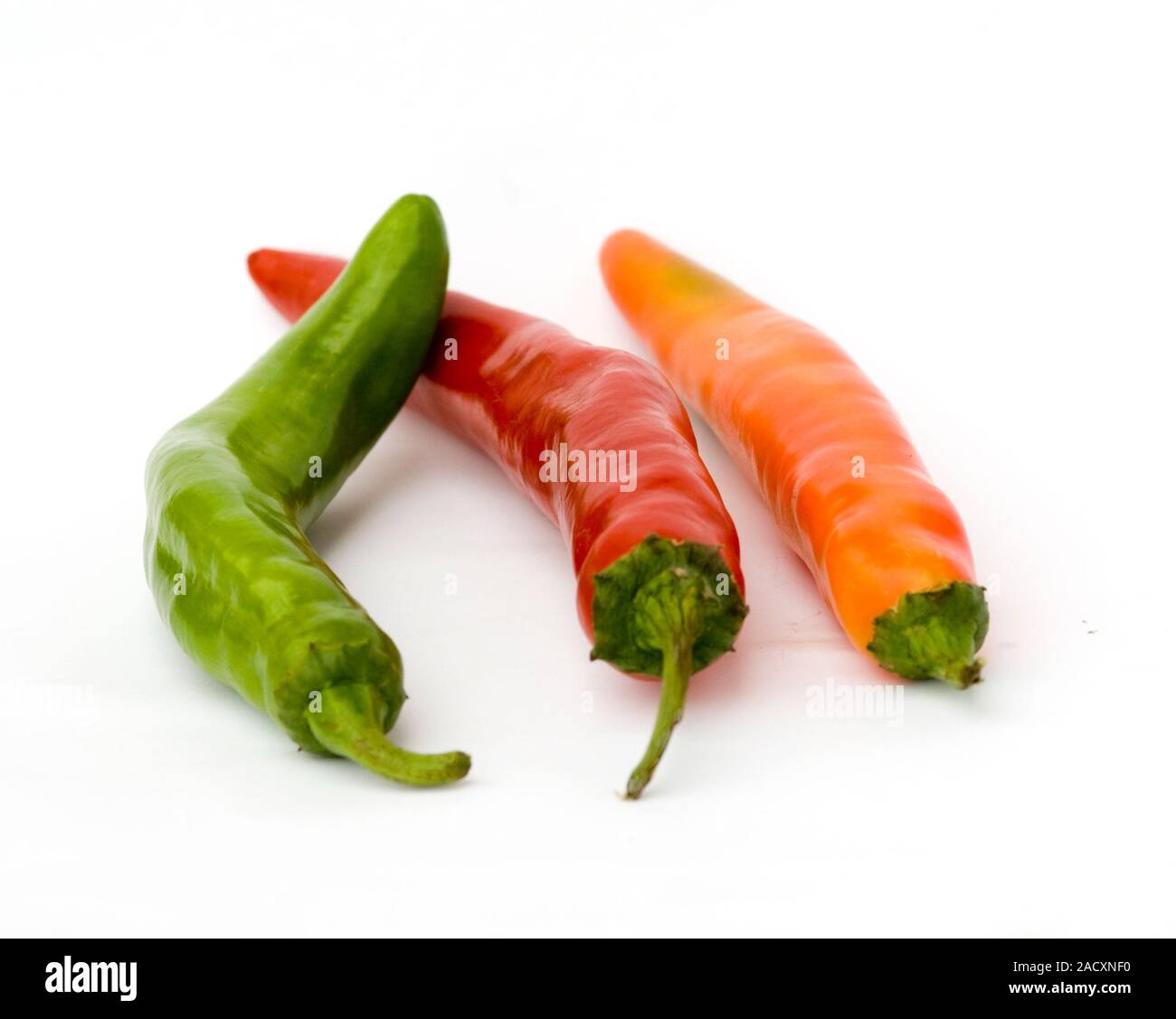 Three red peppers isolated on white background Stock Photo - Alamy