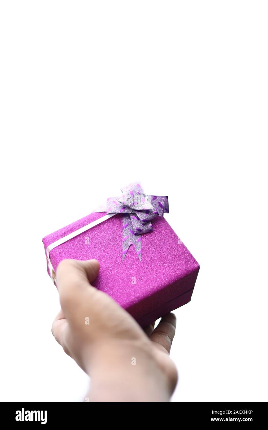 Hands holding a present with a white ribbon hi-res stock photography ...