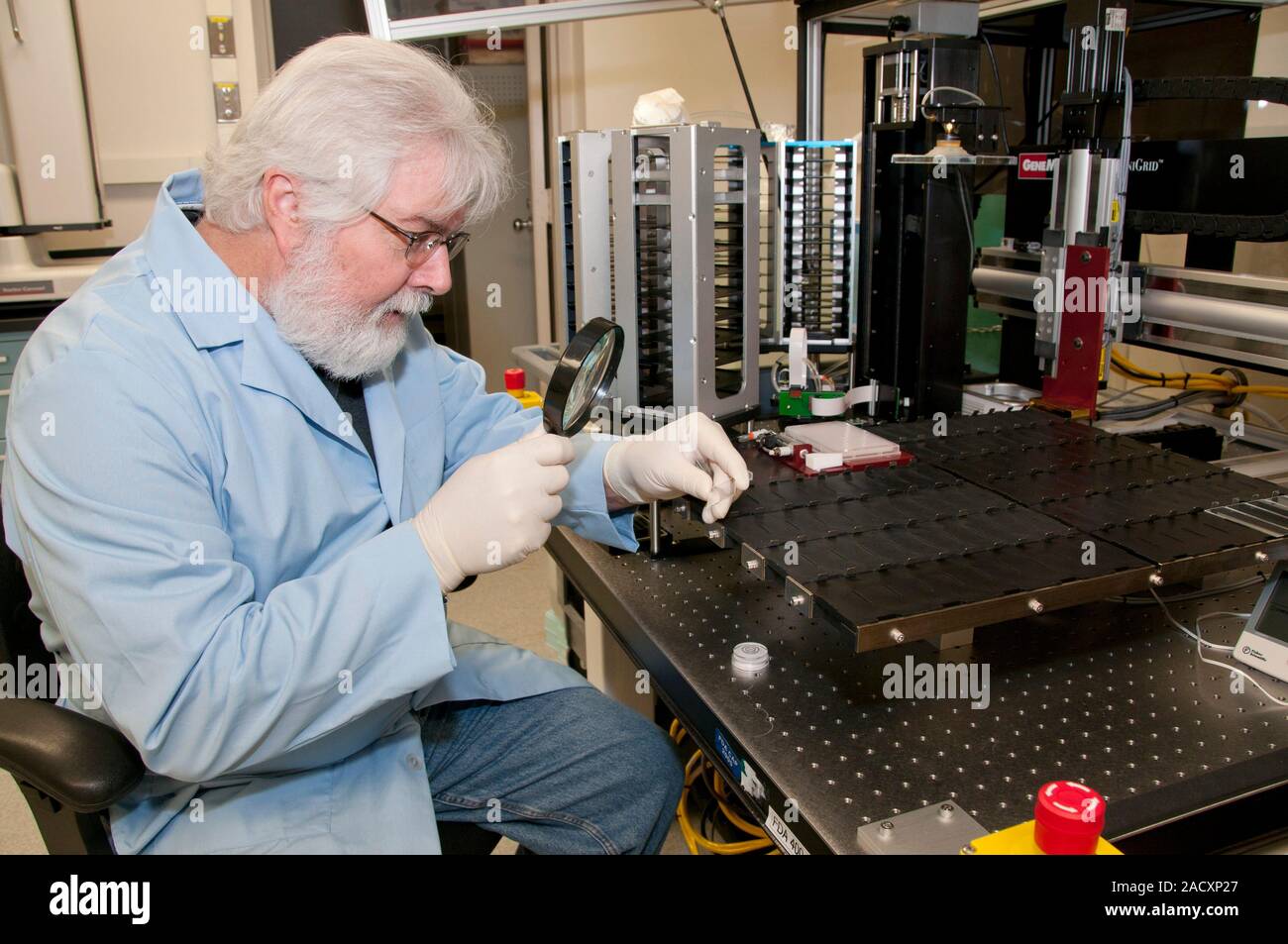 Editorial use only Functional genomics laboratory. Researcher studying a slide in a functional ...