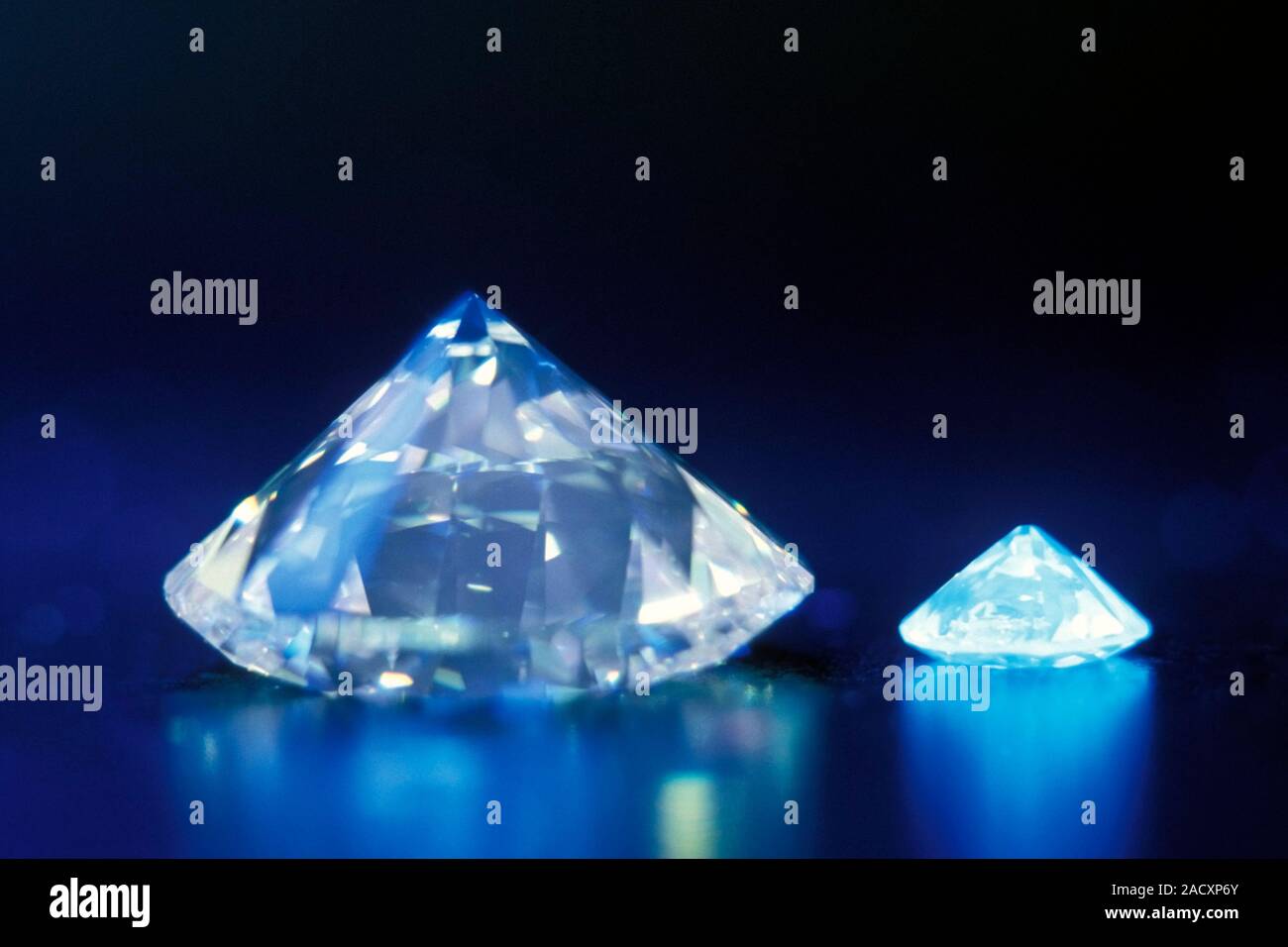Diamonds. Two cut and polished diamonds fluorescing under ultra-violet ...