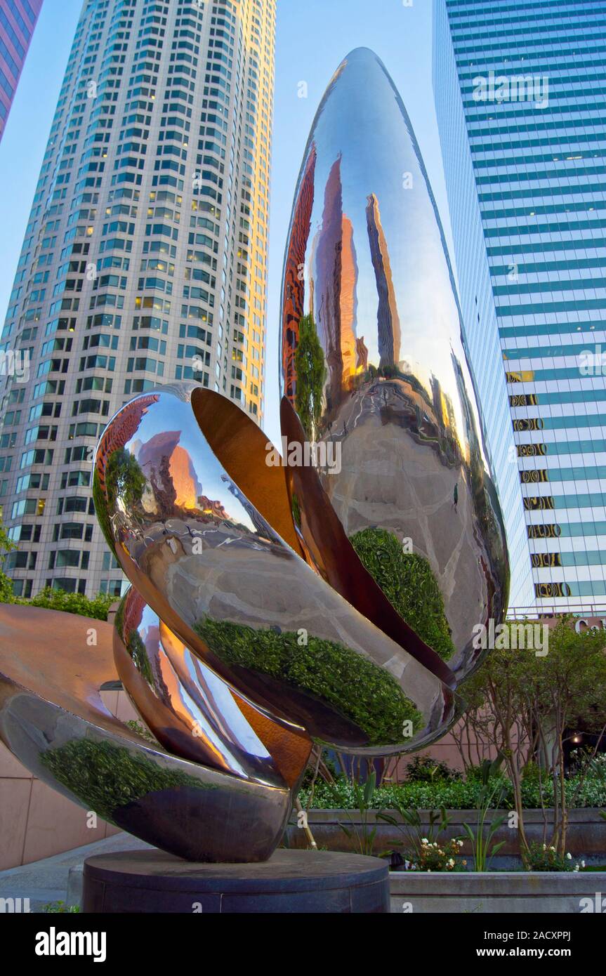 Distorted reflections of surrounding park and buildings in an aluminium ...