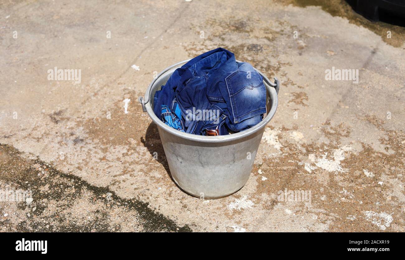 pile of dirty laundry in a washing basket, basket with clean clothes ...