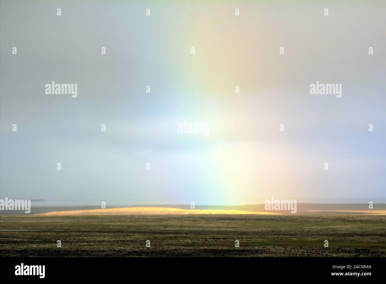 Pale mist rainbow in polar desert. Novaya Zemlya Archipelago. Russian ...