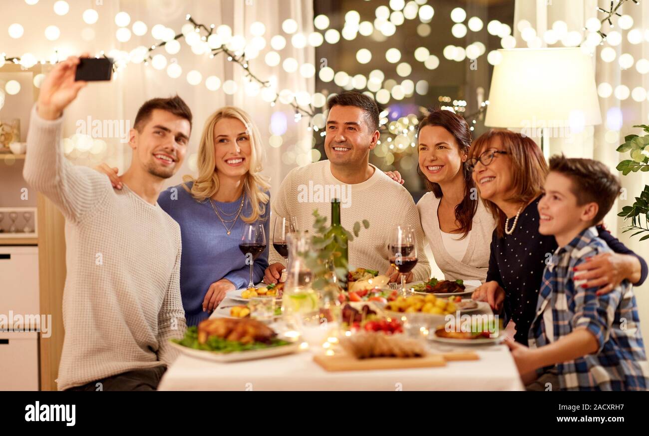 celebration, holidays and people concept - happy family having dinner ...