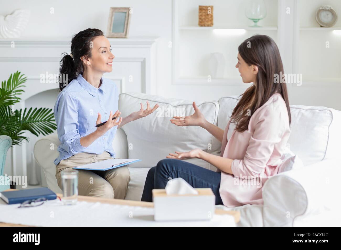 Female patient and psychotherapist having positive inspiring ...