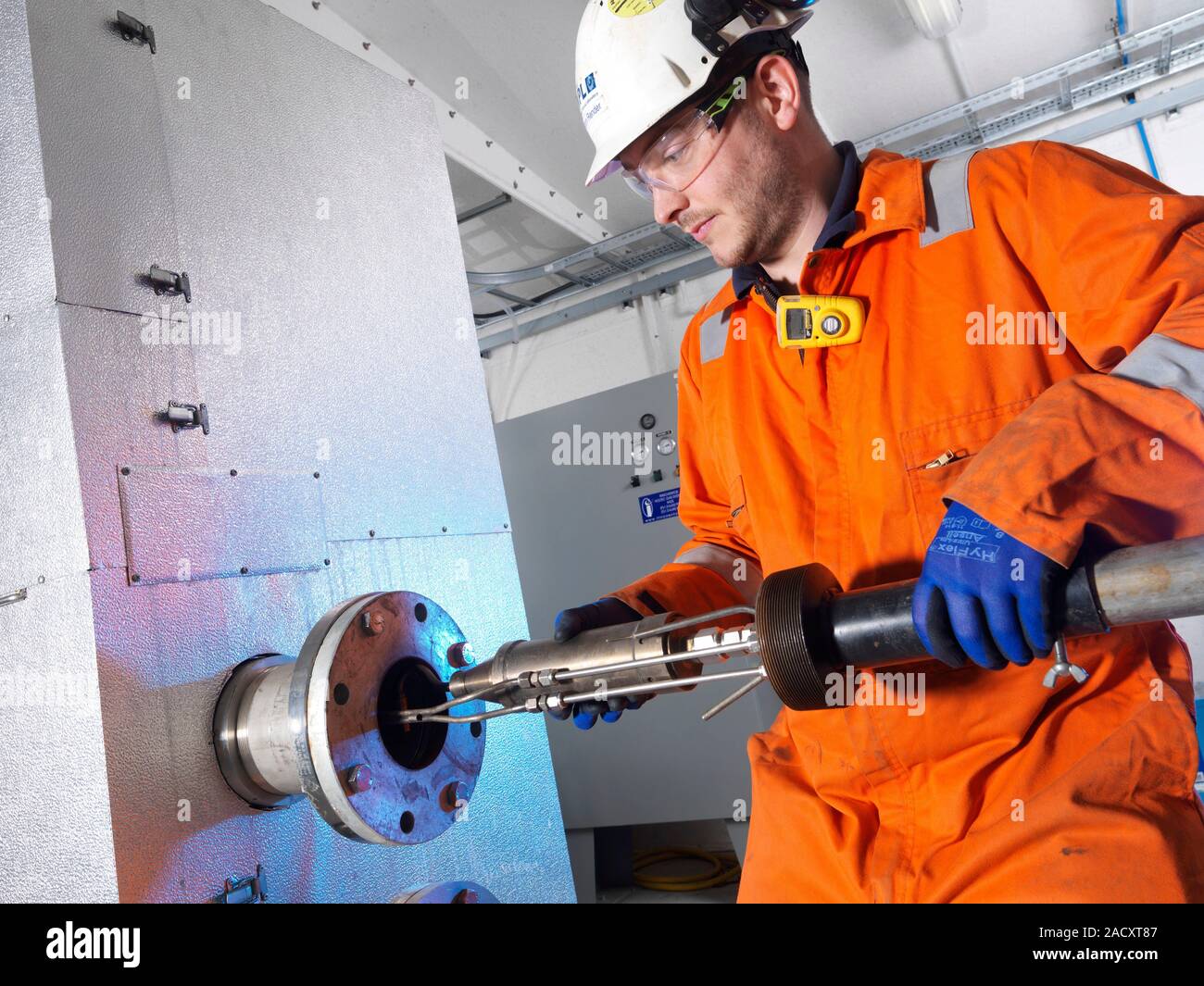Chimney stack simulator. Researcher preparing to sample gases from the ...