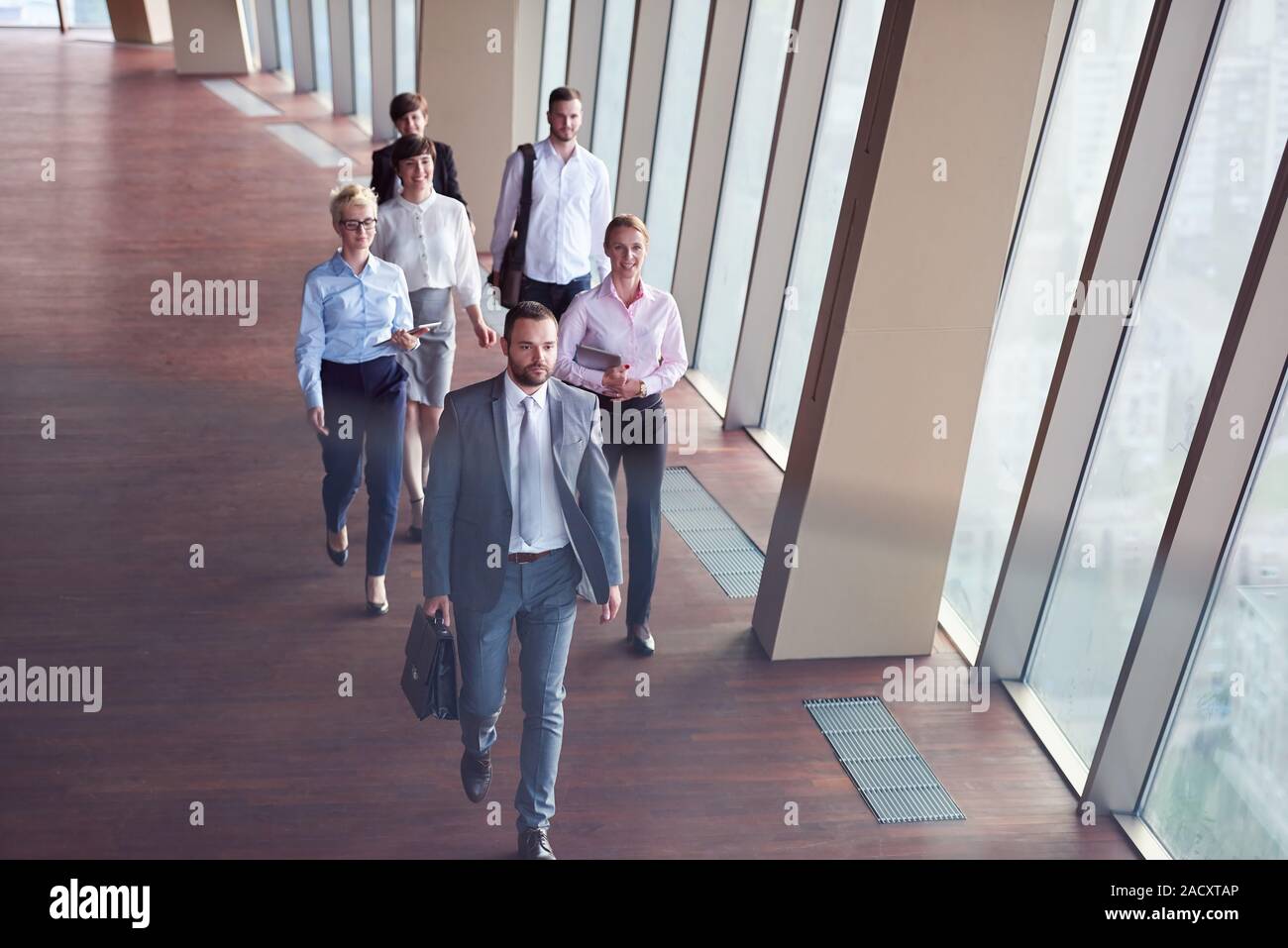 Business partners walking corporate corridor hi-res stock photography ...