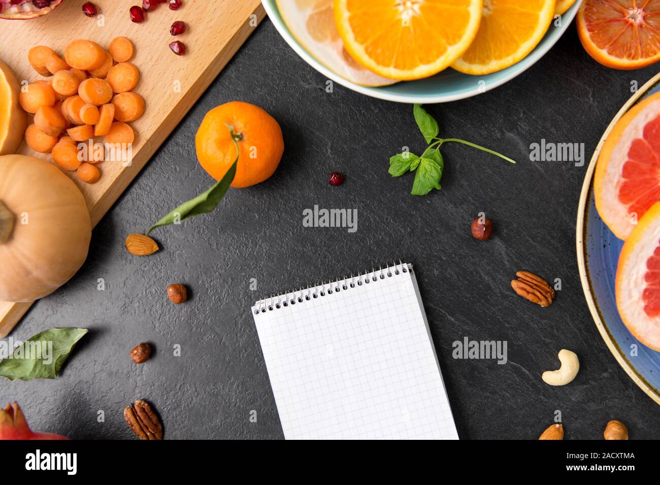 food, healthy eating and diet concept - close up of notebook, fruits ...