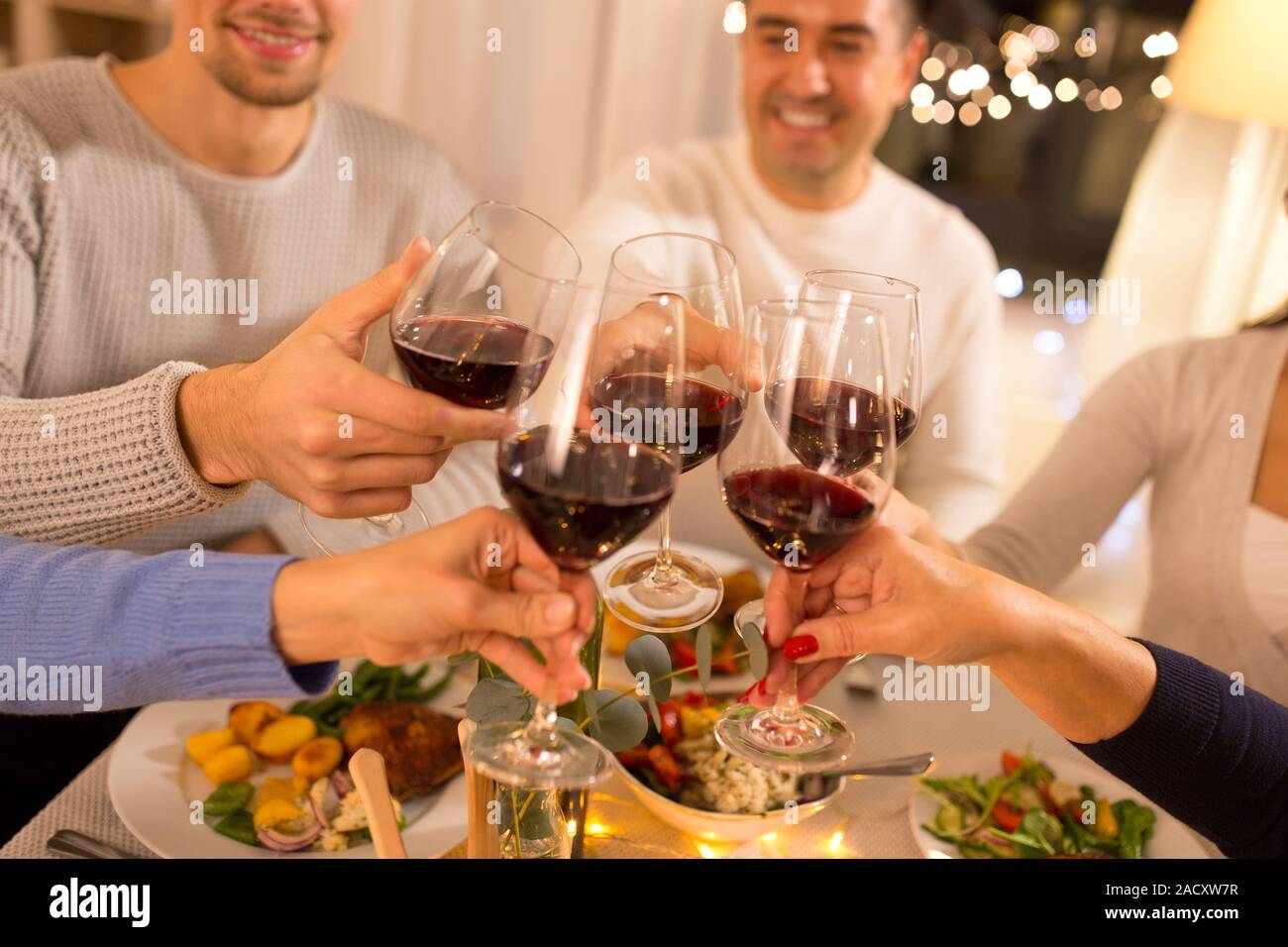 celebration, holidays and people concept - happy family having dinner party, drinking red wine ...