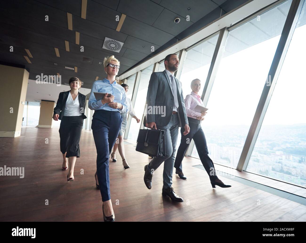 Business partners walking corporate corridor hi-res stock photography ...