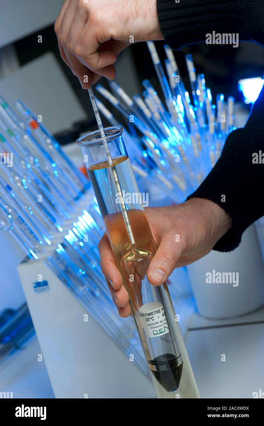 Alcoholmeter being used to test alcohol levels. This instrument is a ...