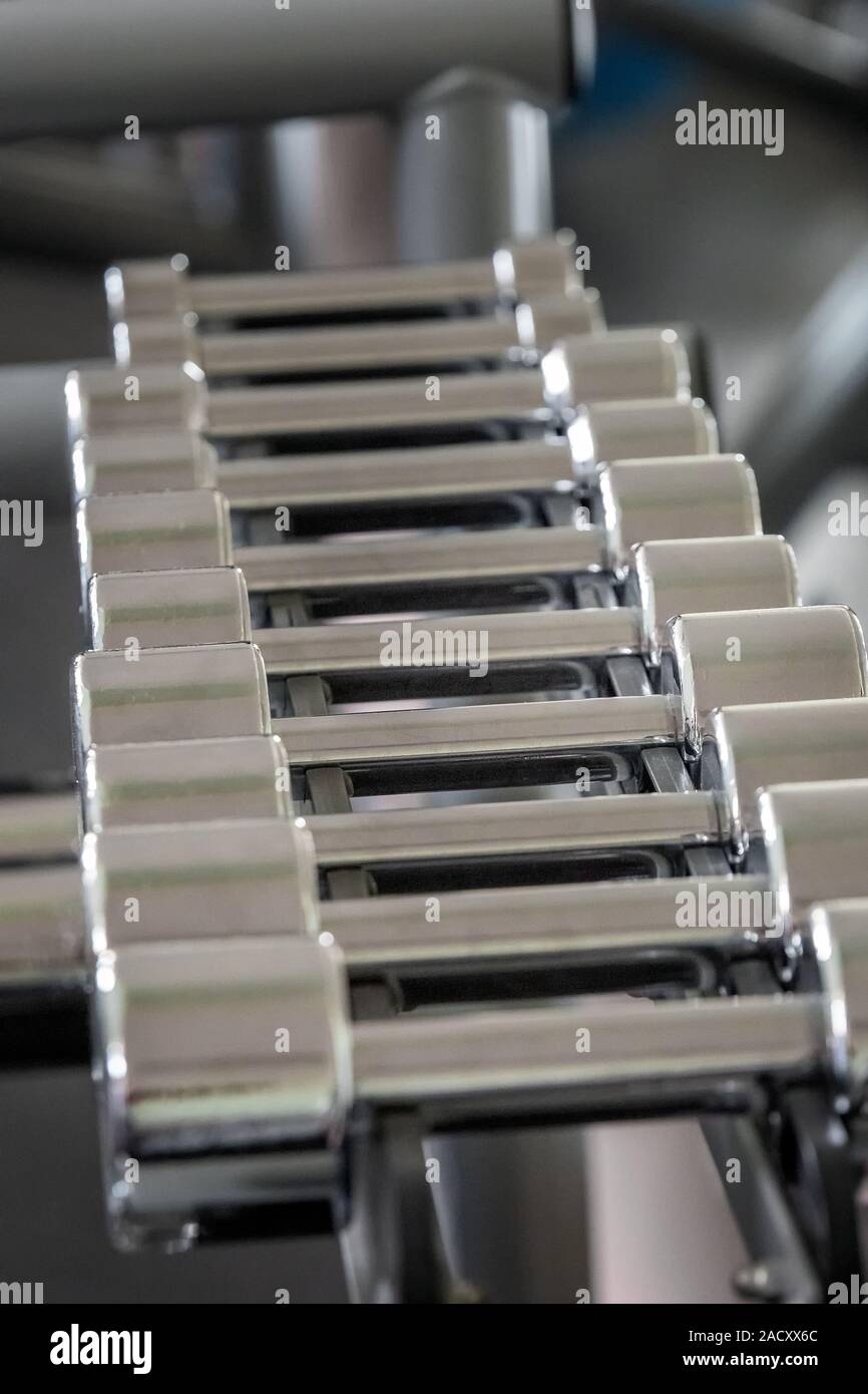 Rack of iron weights in a gym. Close up shot Stock Photo - Alamy