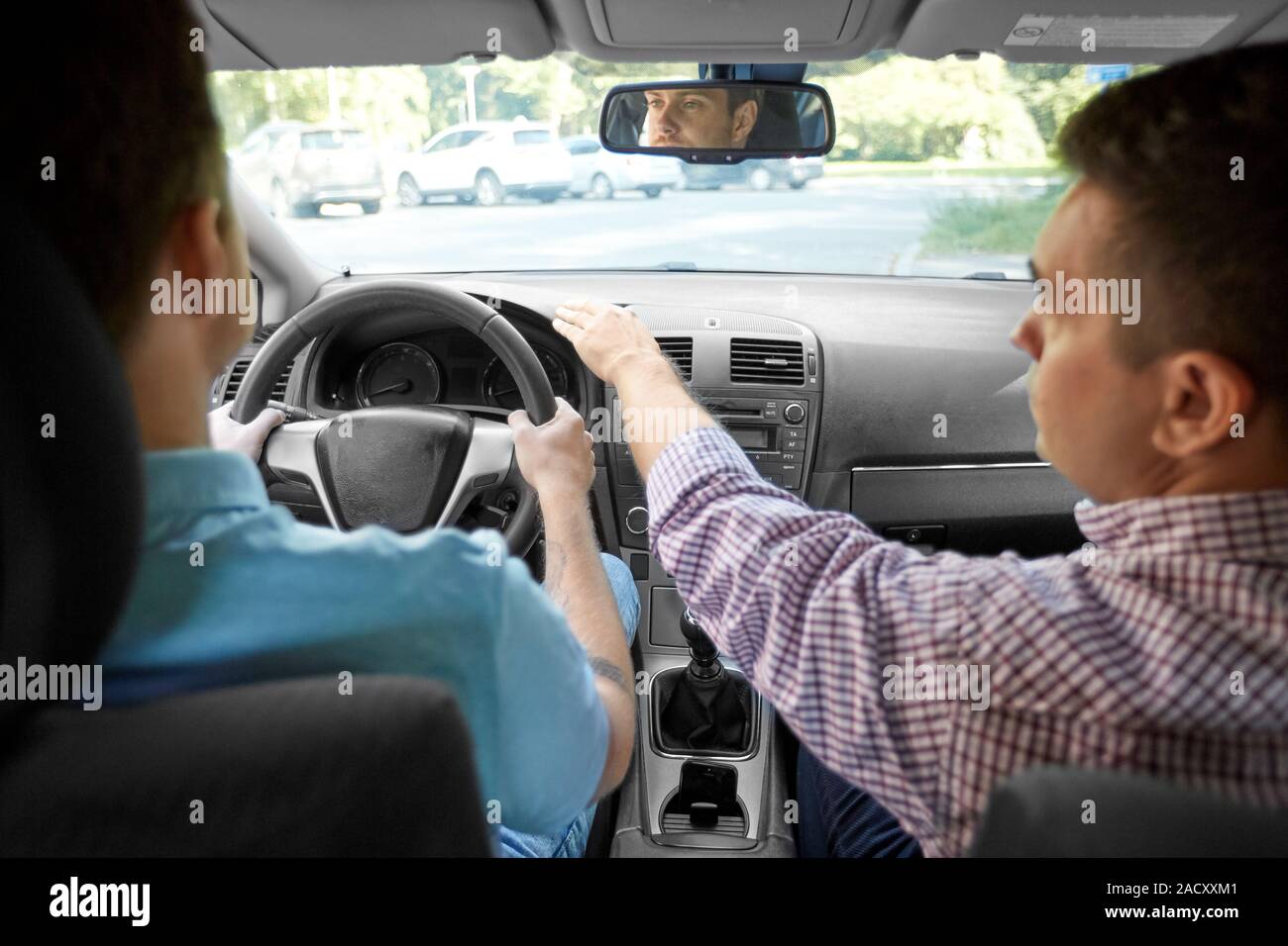 driver courses and people concept - car driving school instructor ...