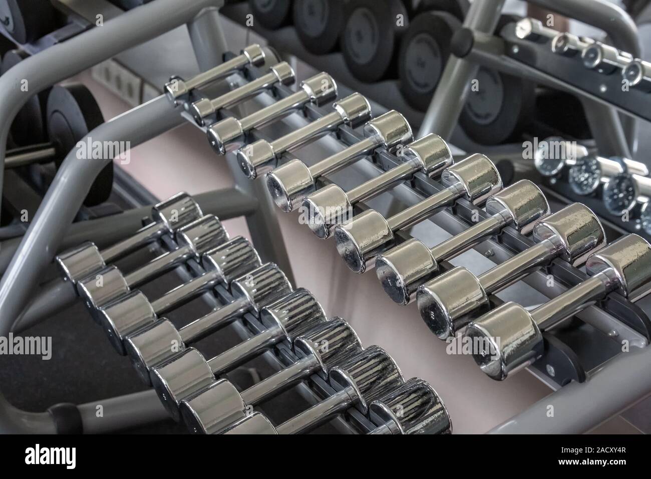 Rack of iron weights in a gym. Close up shot Stock Photo - Alamy