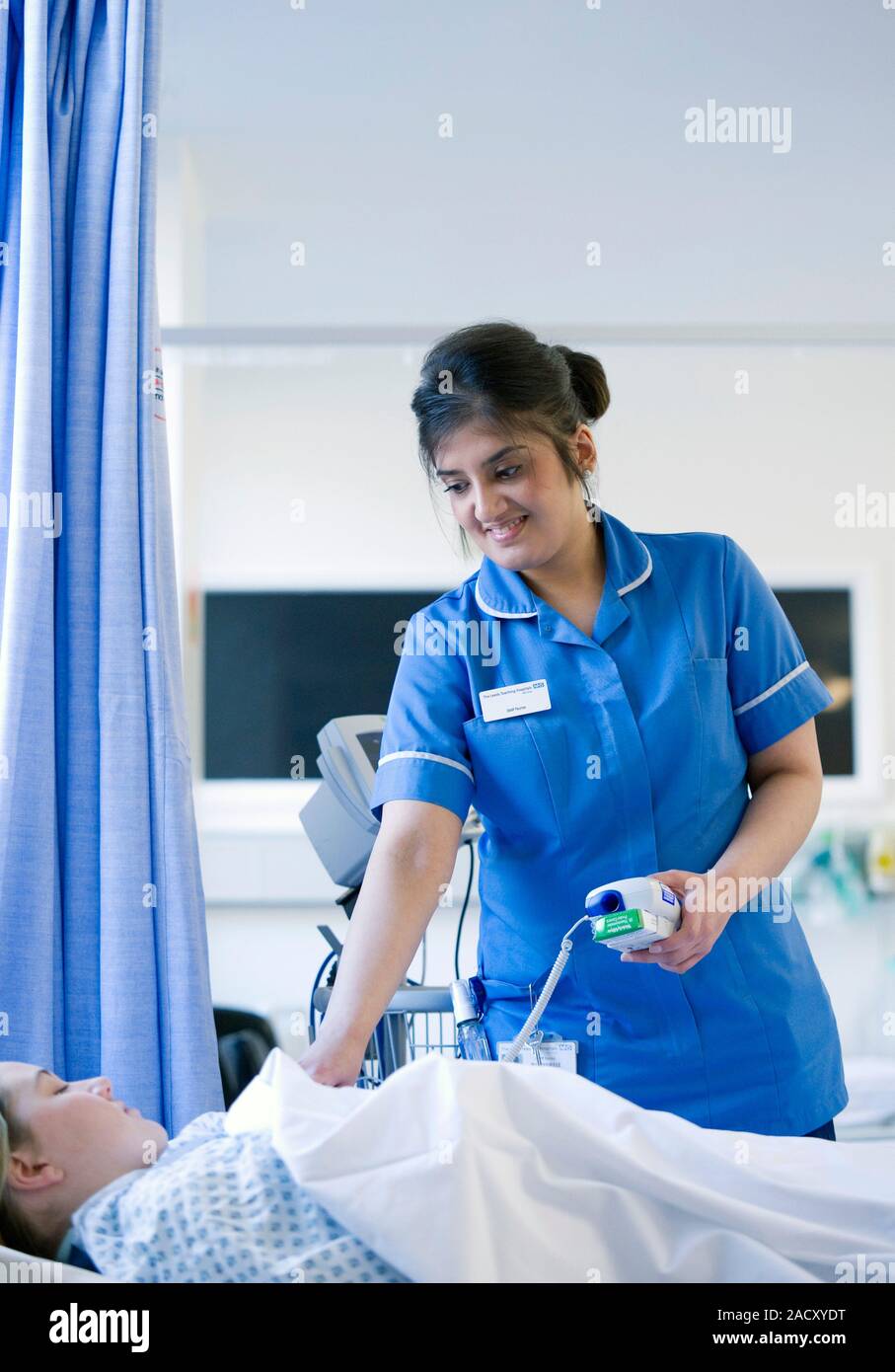 Nurse taking a hospital patient's temperature Stock Photo - Alamy