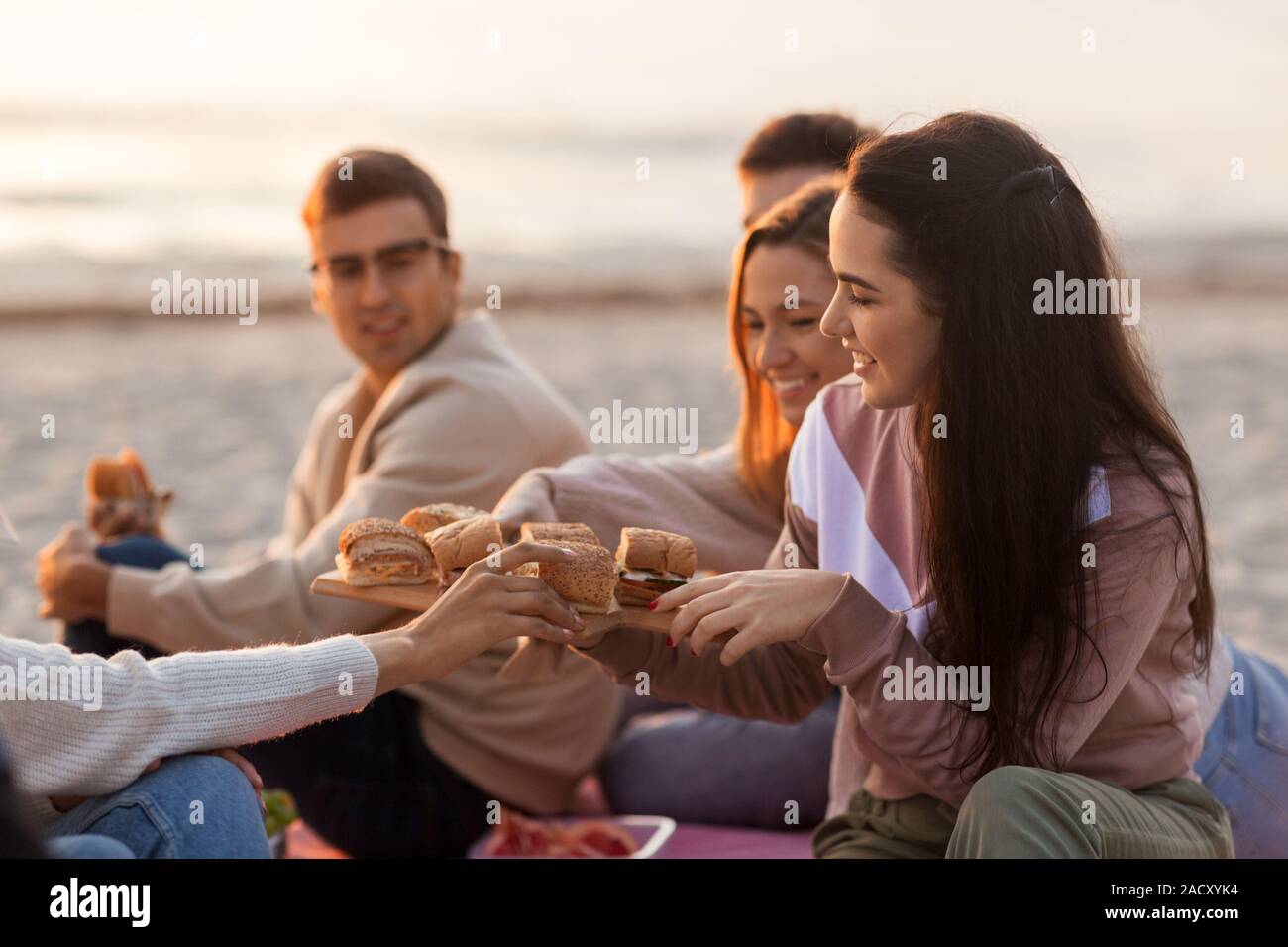 Group happy friends eating sandwiches hi-res stock photography and ...