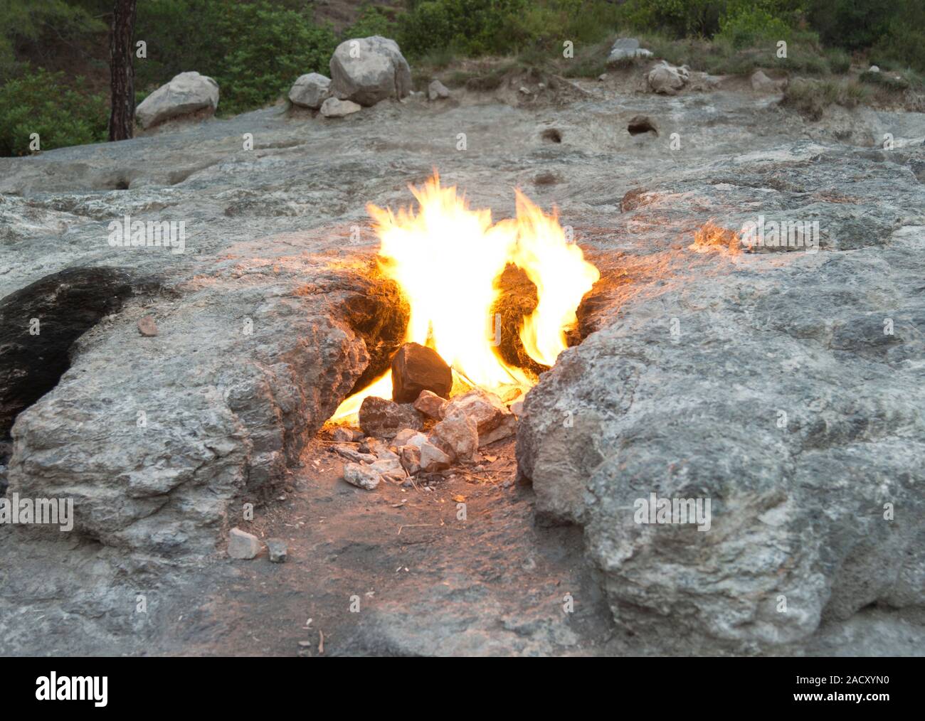 Natural methane fire. Flame of burning methane on Mount Chimera near ...