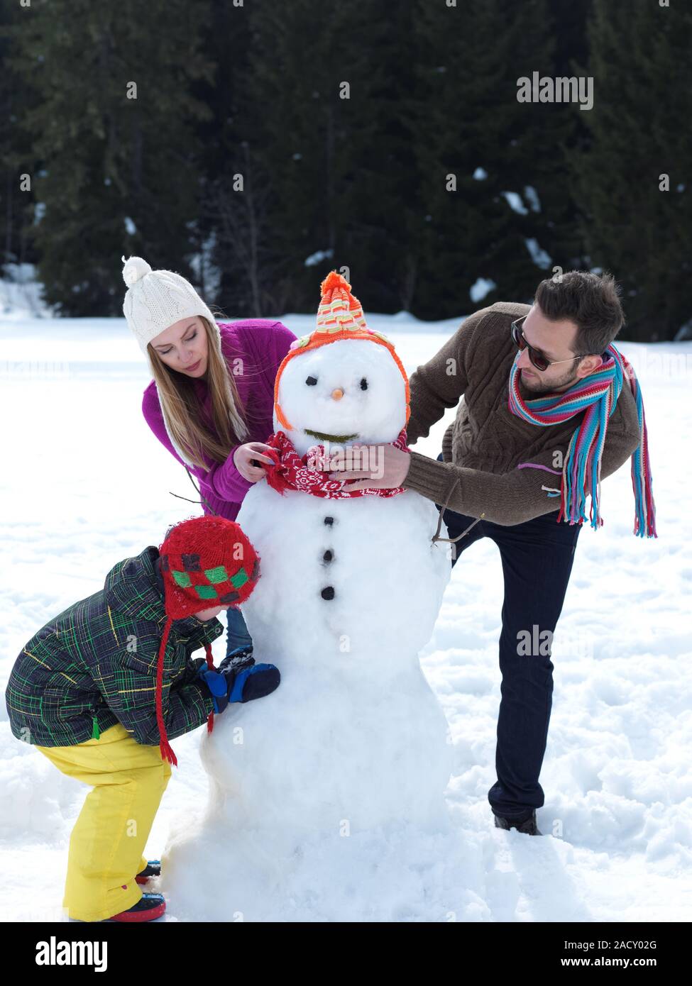 happy family making snowman Stock Photo - Alamy