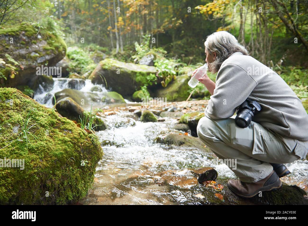 man drinking fresh water from spring Stock Photo - Alamy