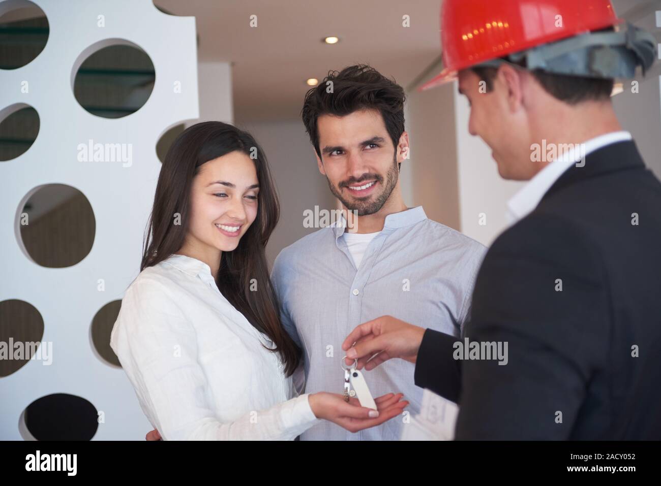 couple buying new home with real estate agent Stock Photo - Alamy