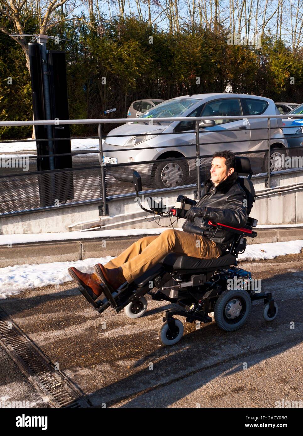 WhING wheelchair testing. User on an access parking ramp to a garage ...